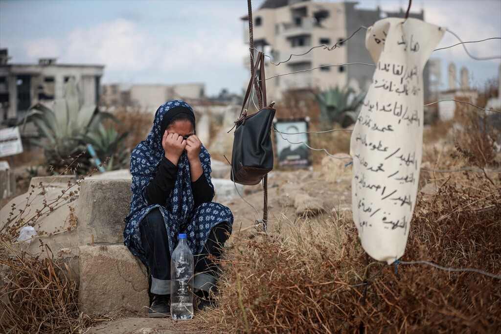 Palestinians visit the graves after Eid prayers in Gaza