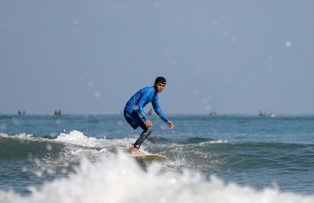 Young Gazans turn to surfing amid hardship and summer heat
