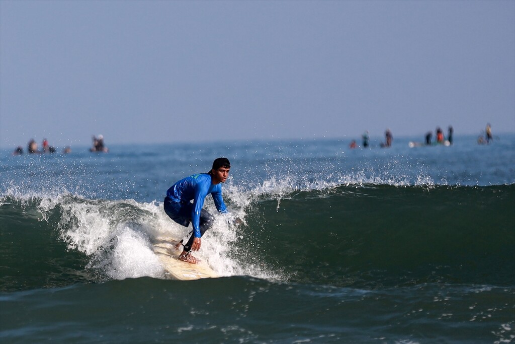 Young Gazans turn to surfing amid hardship and summer heat